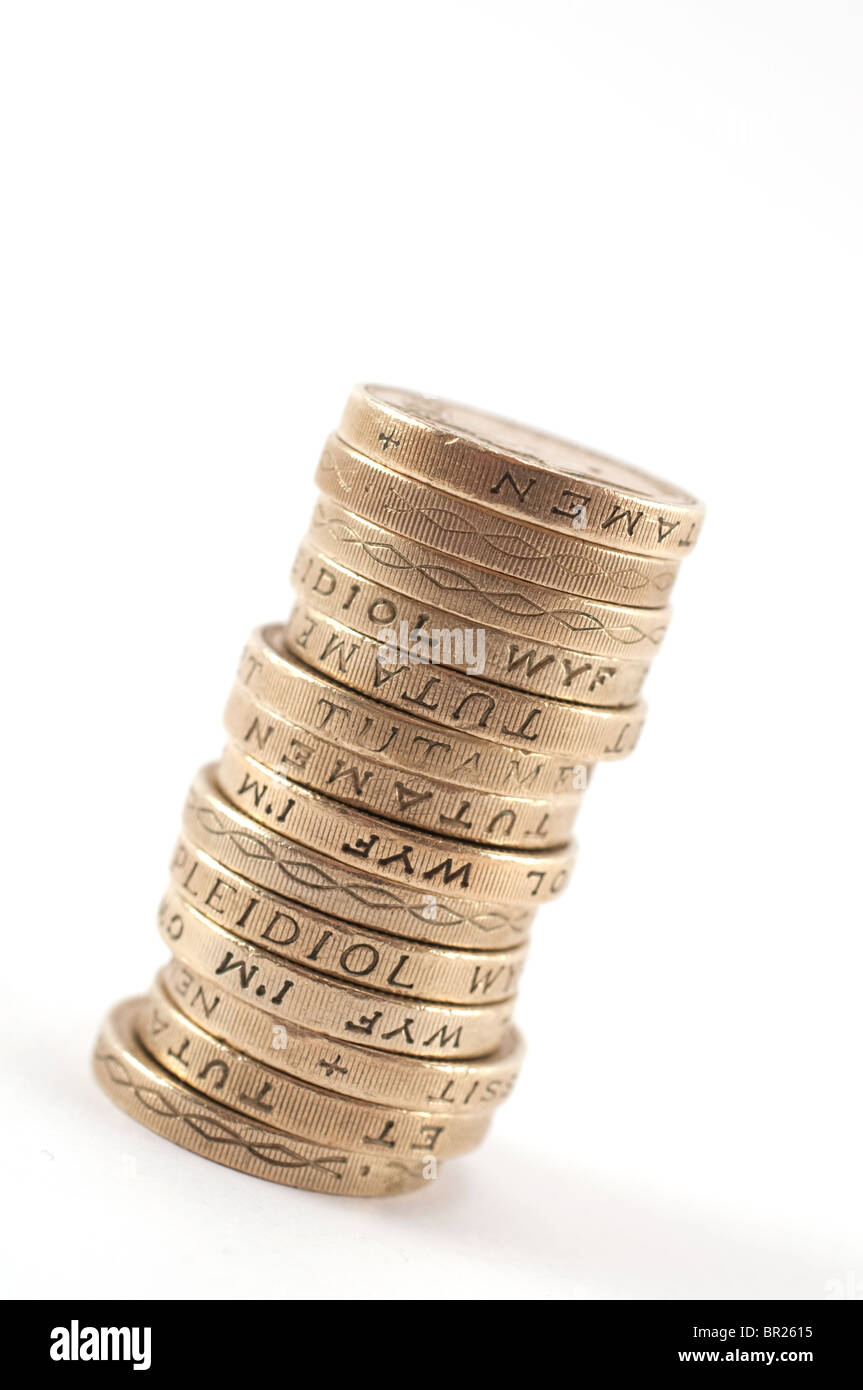Stack of british one pound coins at an angle and isolated on white ...