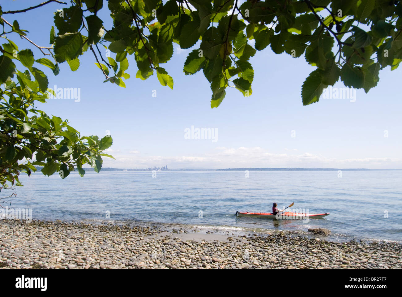 A woman kayaking on June 9, 2007 along Bainbridge Island in Puget Sound ...