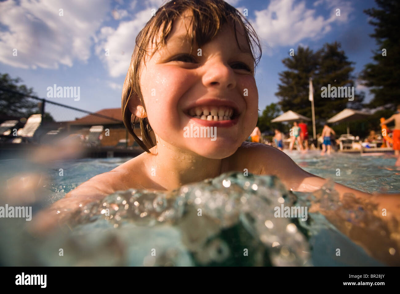 A small boy plays in a pool Stock Photo - Alamy