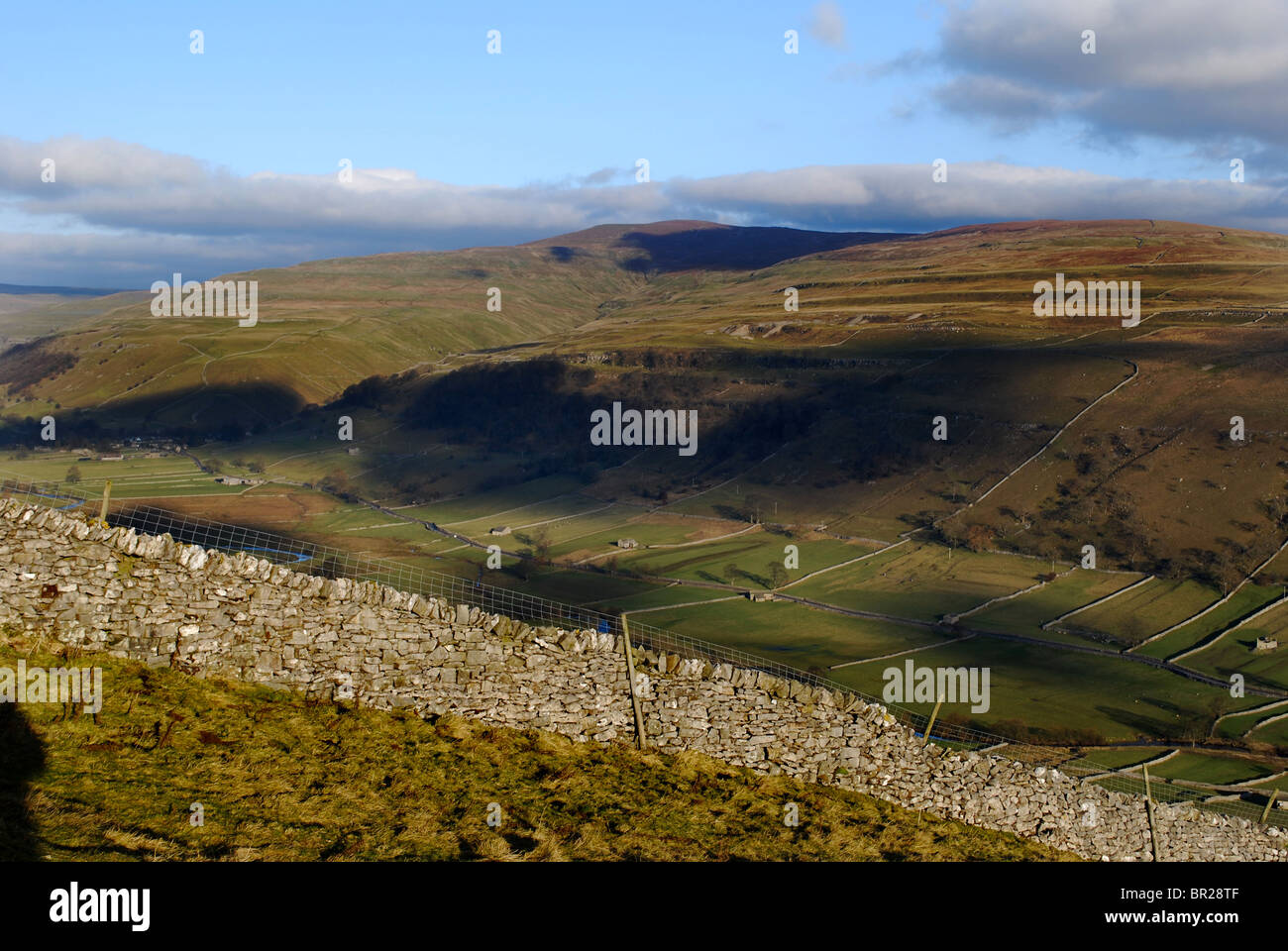 Dappled light on the U shaped valley of the River Wharfe criss-crossed ...