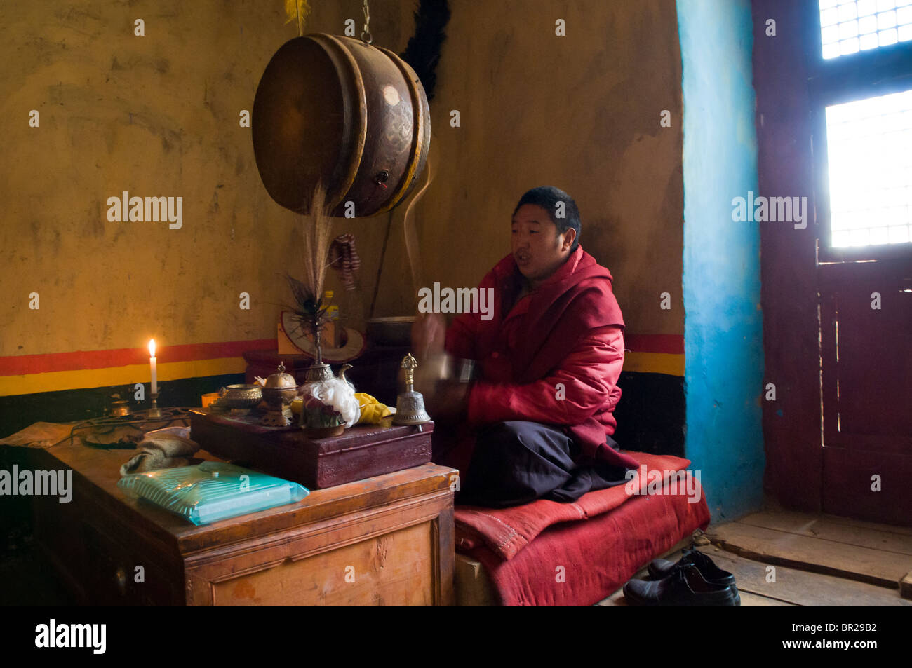 Tibetan Buddhist monk chants, plays drum and cymbals, Juli Monastery ...