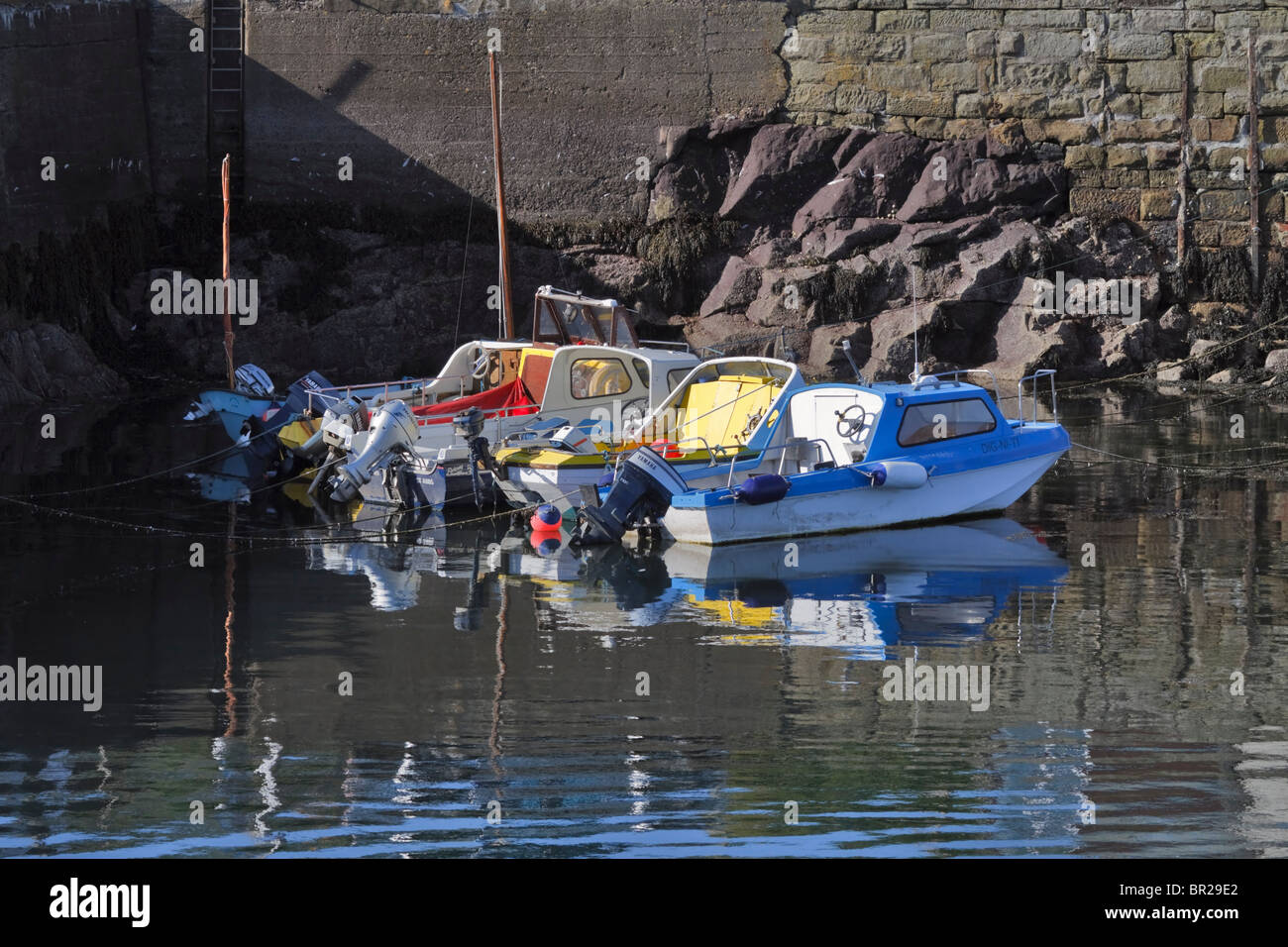 Fishing dinghies at anchor in the harbour at St Abbs, Scotland Stock ...