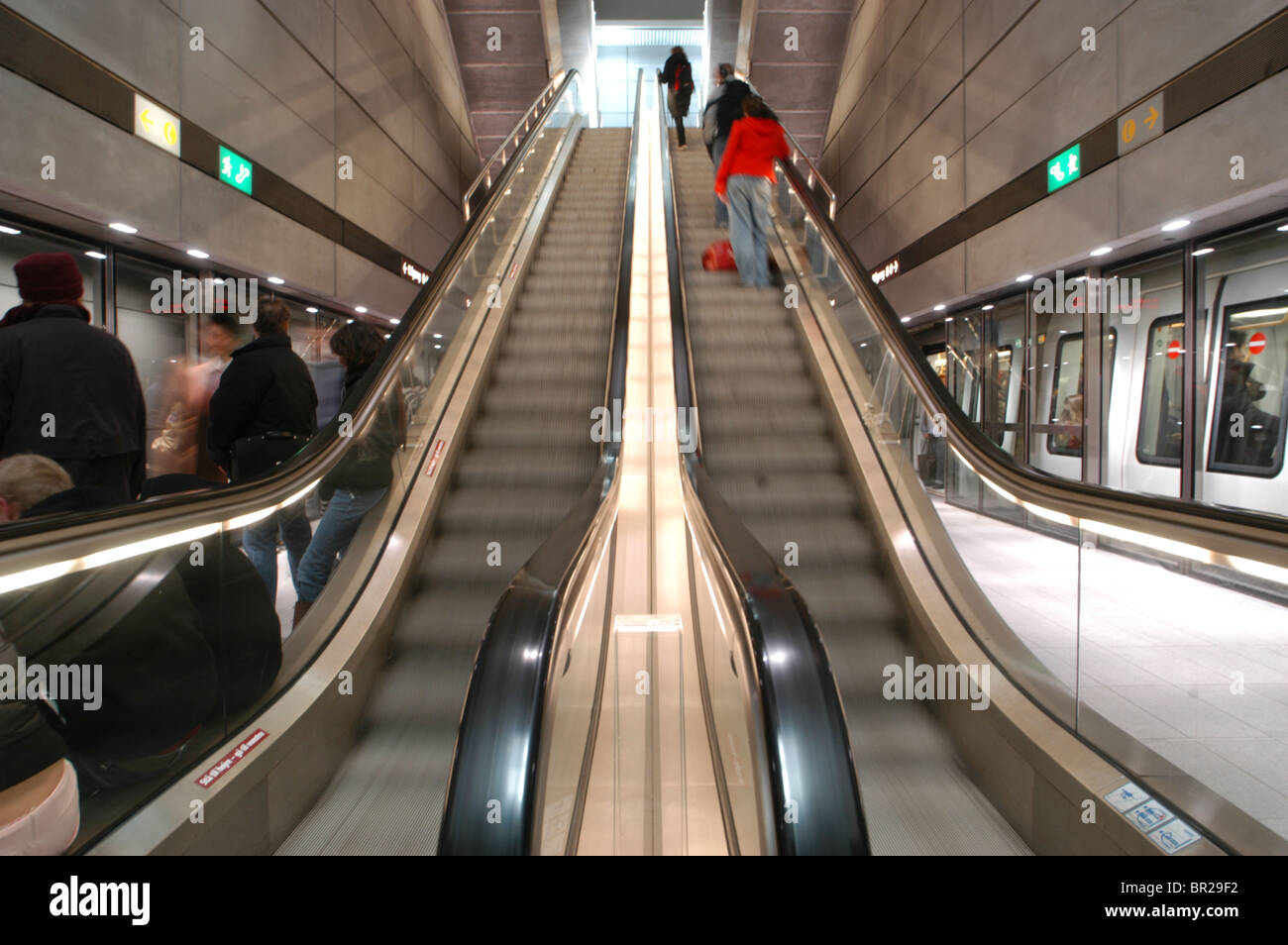 Commuters ride the escalator and board subway trains in Copenhagen ...