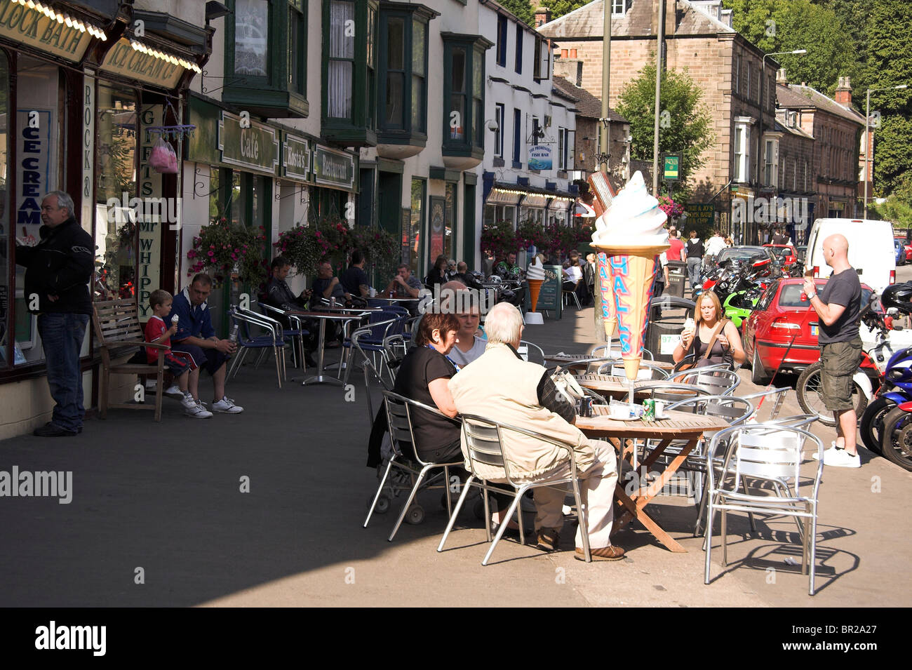 Tourists eating ice cream at a pavement cafe, Matlock Bath, Derbyshire ...