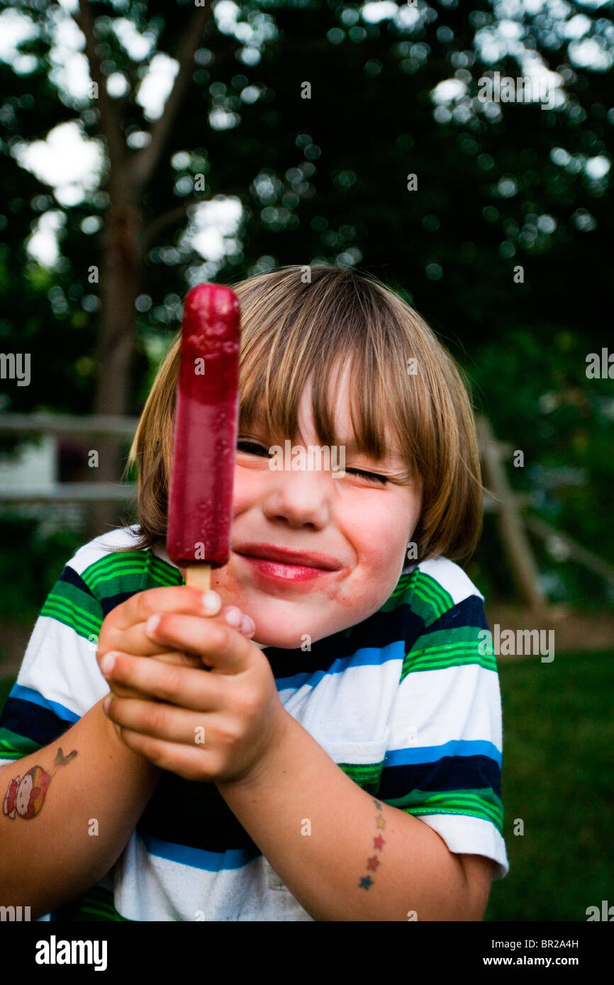 A small boy enjoys a popcicle Stock Photo - Alamy