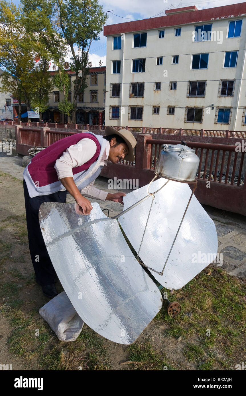 Tibetan shop keeper tends solar powered tea kettle , Xin Du Qiao ...