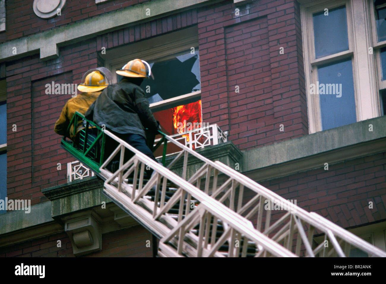 Firefighters / Firemen on Ladder fighting Fire through Broken Window in ...