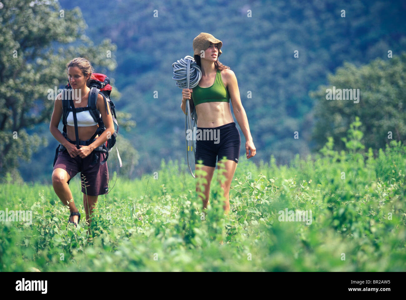 Two women on their approach hike to go climbing Stock Photo - Alamy