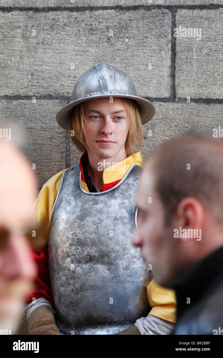Medievally soldier style dressed young guard on due at the gate of ...