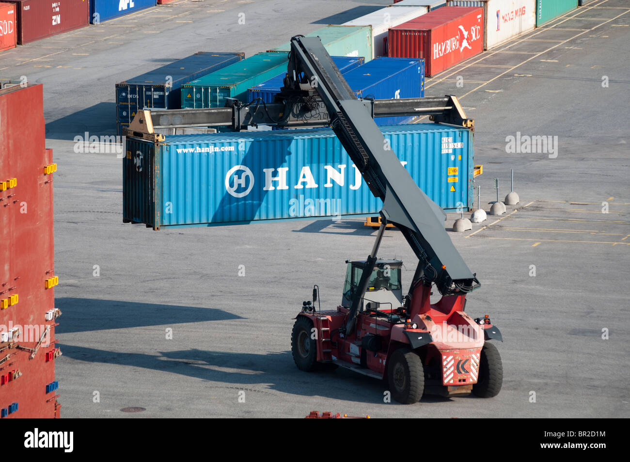A container transporter carrying a container to a new location in the ...