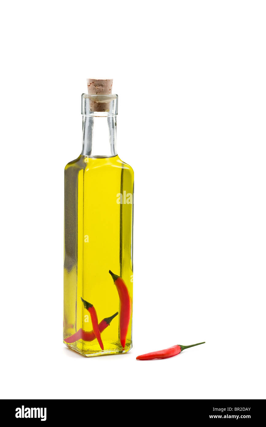Chili infused olive oil over white background Stock Photo - Alamy