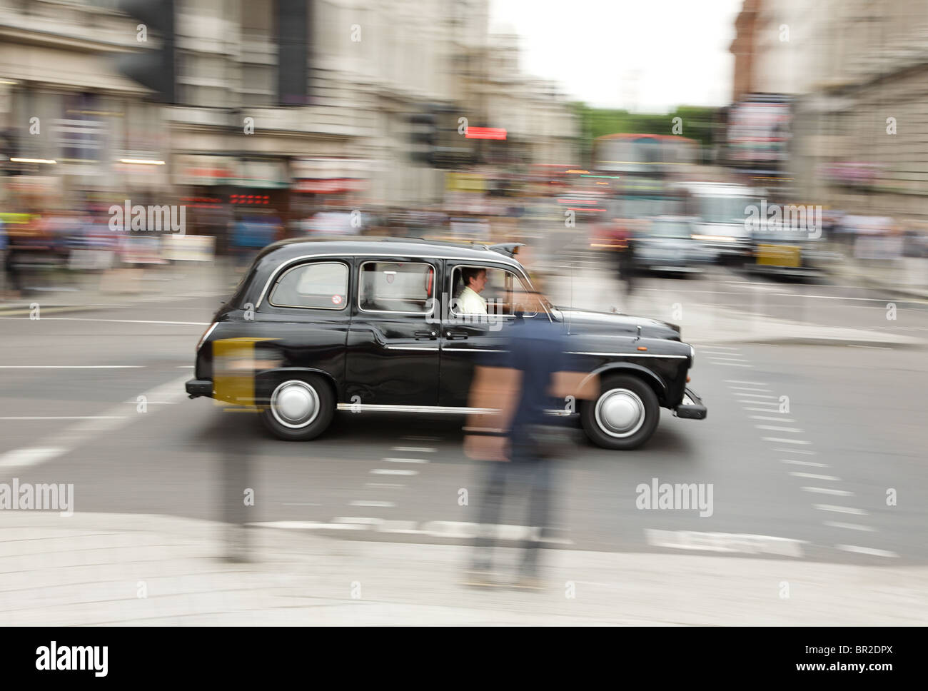 London taxi driving around Charing Cross Stock Photo - Alamy