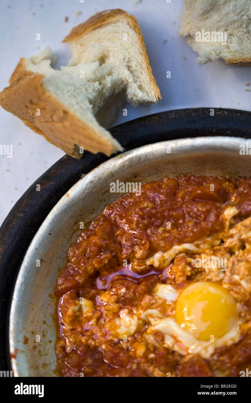A dish of shaksouka - a tomato and egg dish cooked with herbs and ...