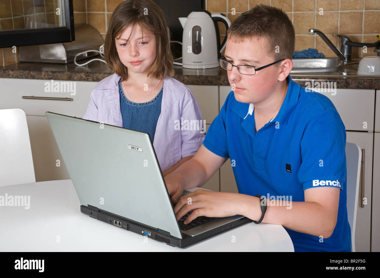 Brother and sister using laptop computer Stock Photo - Alamy