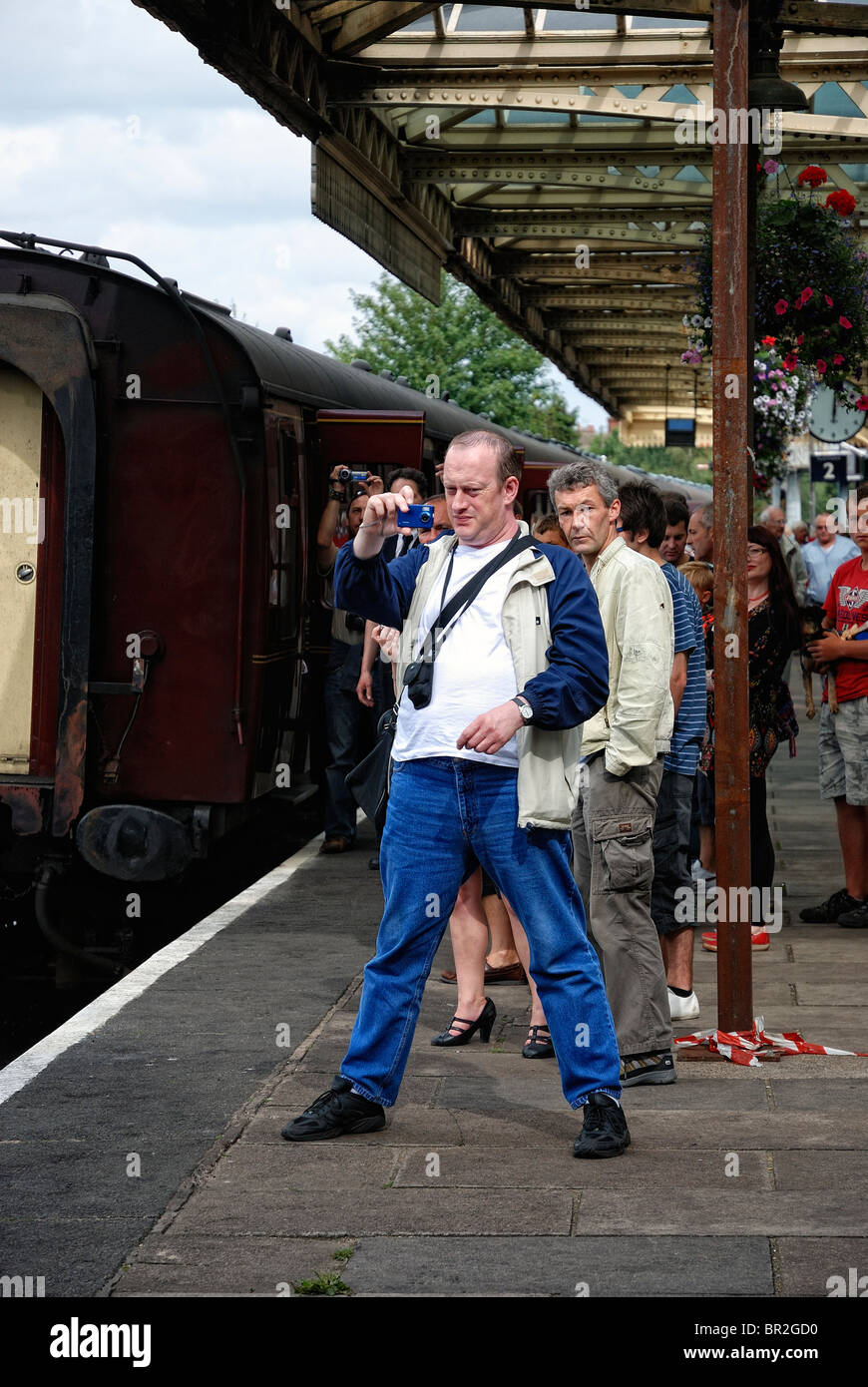 railway enthusiasts taking pictures of train at great central railway ...