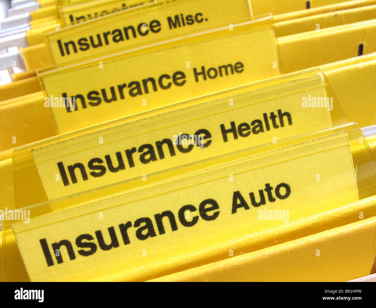 Yellow folders show different types of insurance papers Stock Photo - Alamy