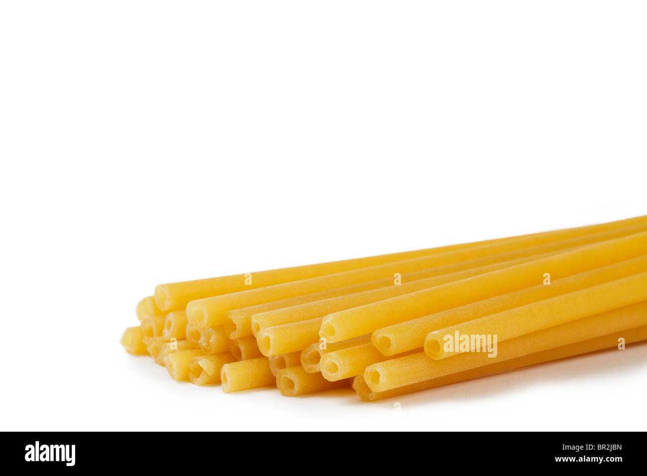 raw yellow macaroni isolated on white background Stock Photo - Alamy