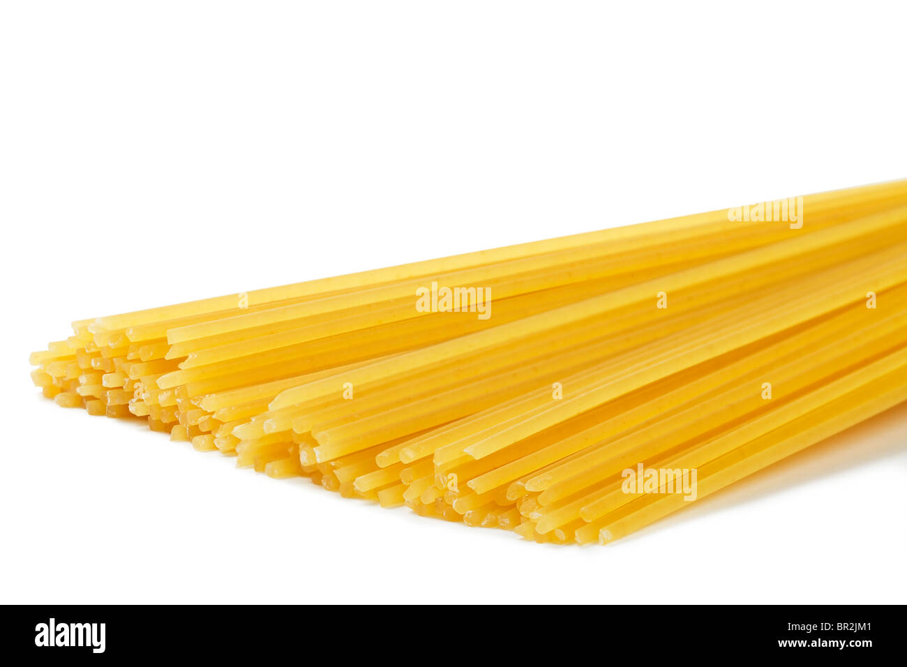 raw yellow spaghetti isolated on white background Stock Photo - Alamy