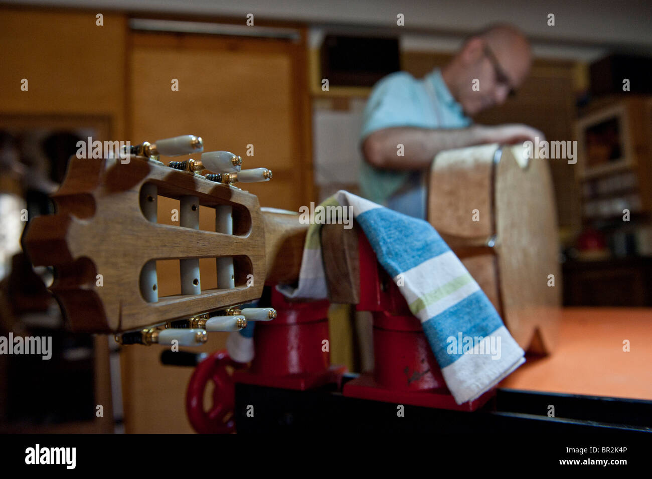 Master Luthier (Guitar-Maker) in his workshop in the process of making ...