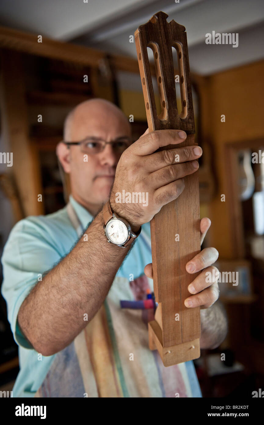 Master Luthier (Guitar-Maker) in his workshop in the process of making ...