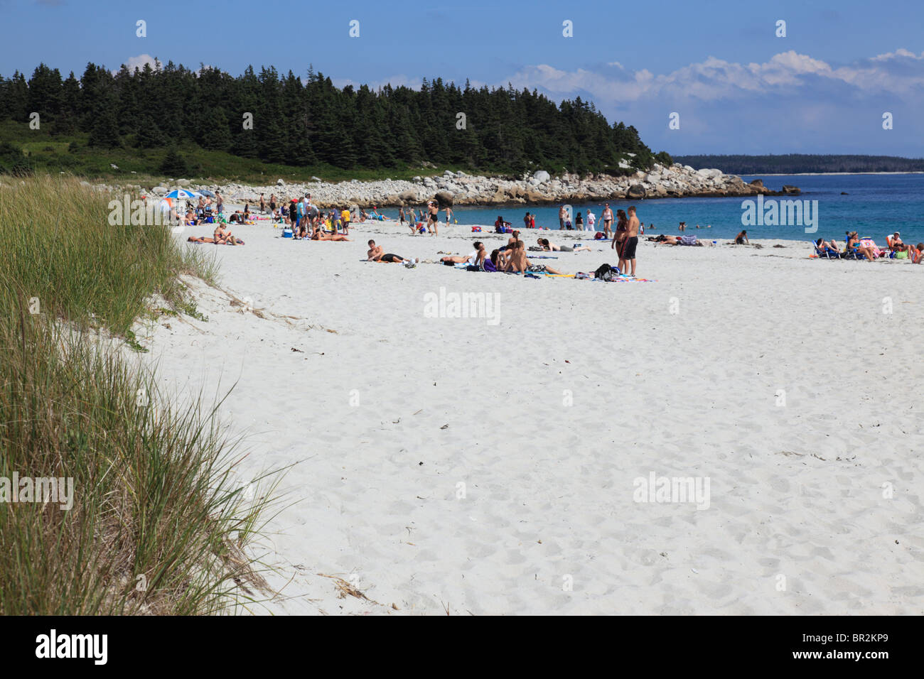 people relaxing on the sandy beach of Crystal Crescent Beach, Halifax ...