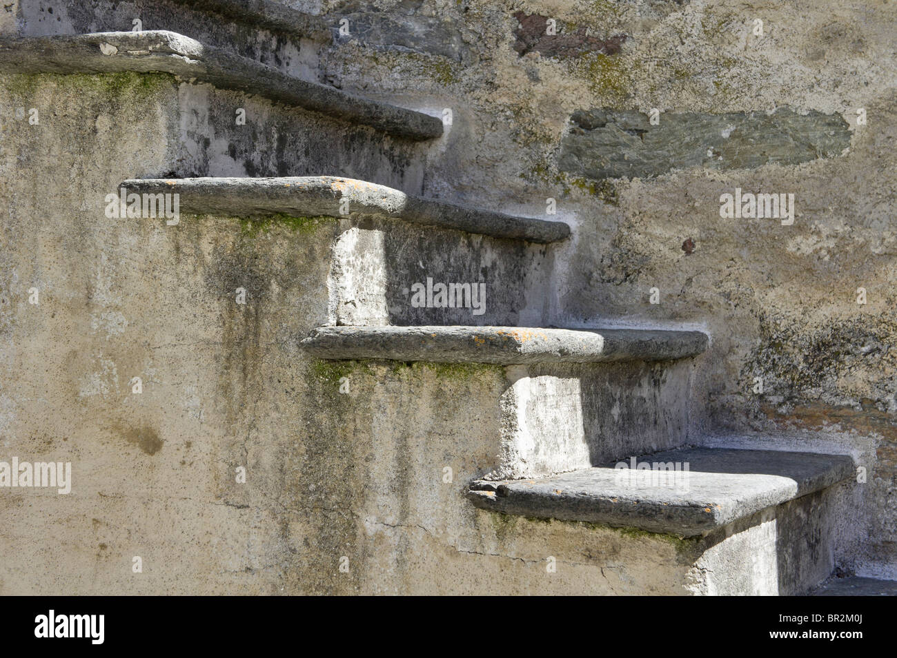 Old stone steps climb up the side of a wall Stock Photo - Alamy