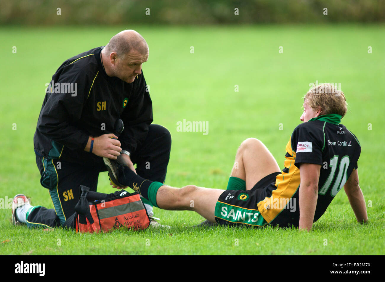 rugby player receives treatment for an injury Stock Photo - Alamy