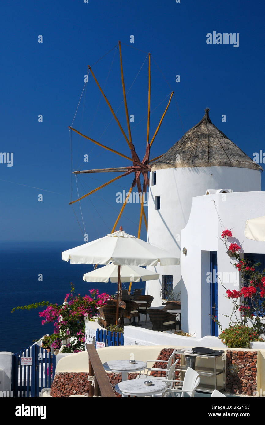 A windmill next to a restaurant in Oia, Santorini Island, Greece Stock ...