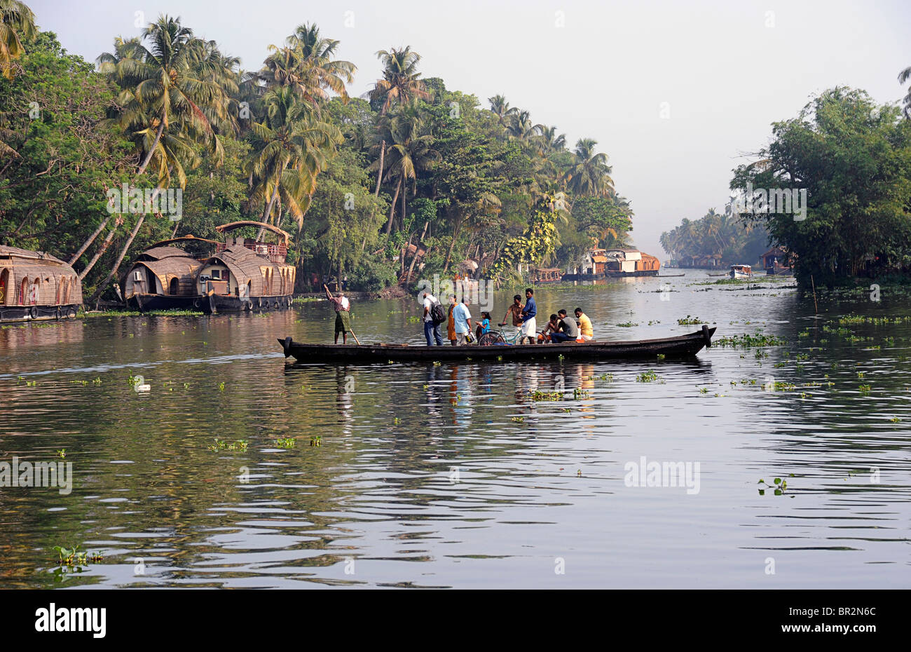 Transporting a boatload of passengers across the river. Alleppey ...
