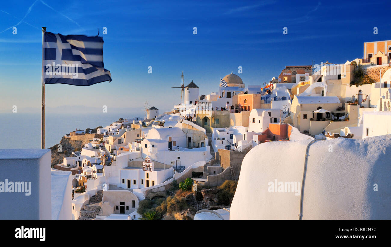 The town of Oia is covered in the golden light of the setting sun. Oia ...
