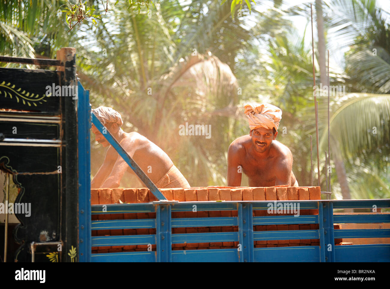 Indian workmen unloading bricks, Kovalam, Kerala, India Stock Photo - Alamy