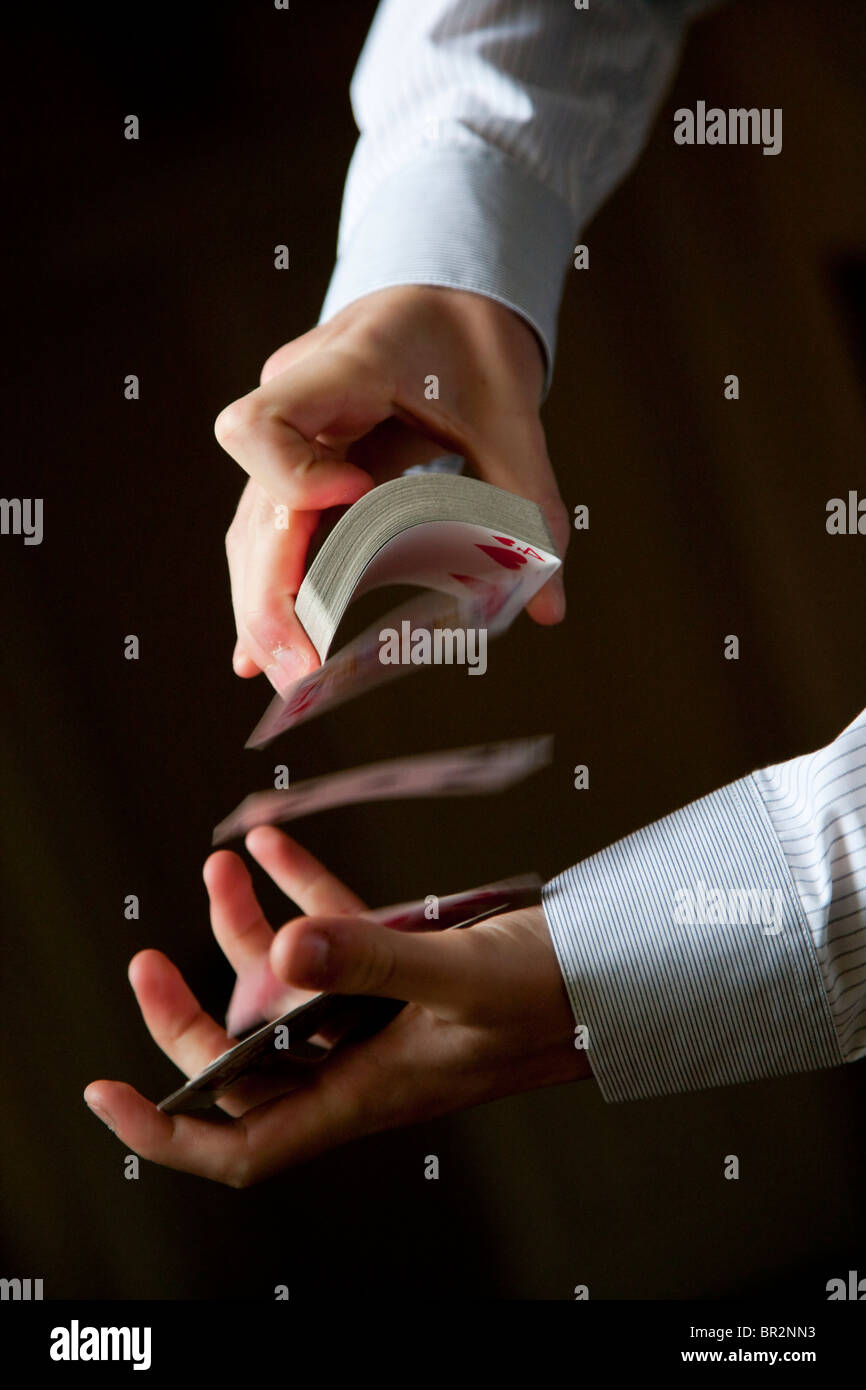 Magician shuffling playing cards Stock Photo - Alamy