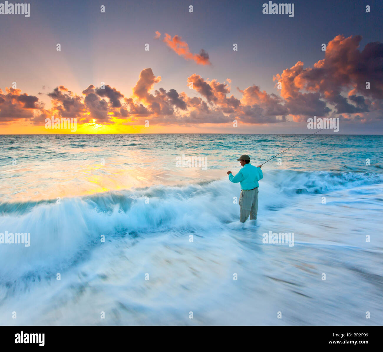 Man fly fishing in the surf of ocean at the beach Stock Photo - Alamy