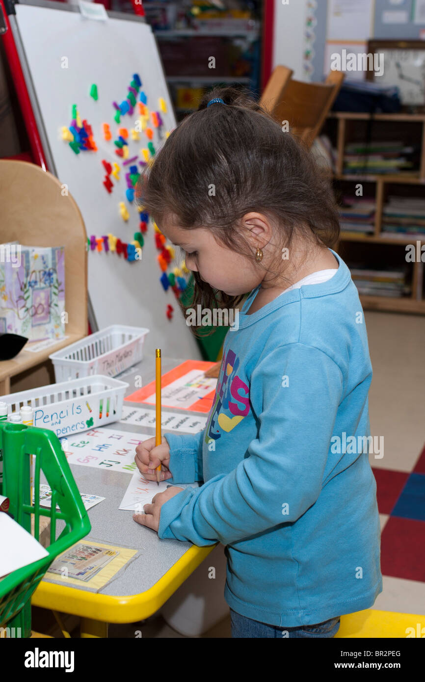 4 year old preschool girl writing a letter in her classroom Stock Photo ...