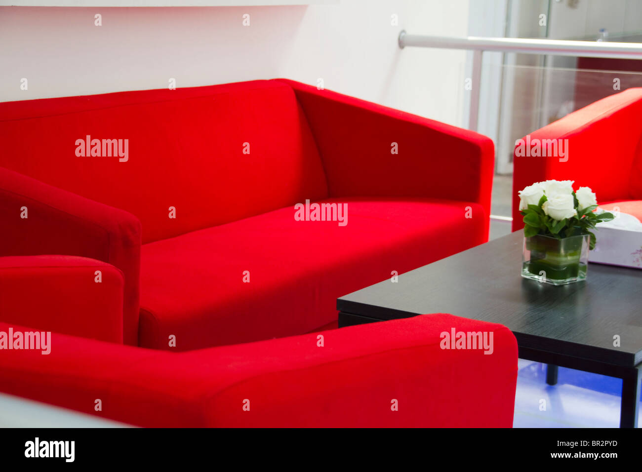 a red long sofa in the living room Stock Photo - Alamy