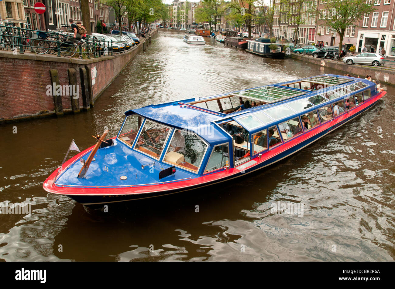 Boat making a turn in one of the Amsterdam Channels Stock Photo - Alamy