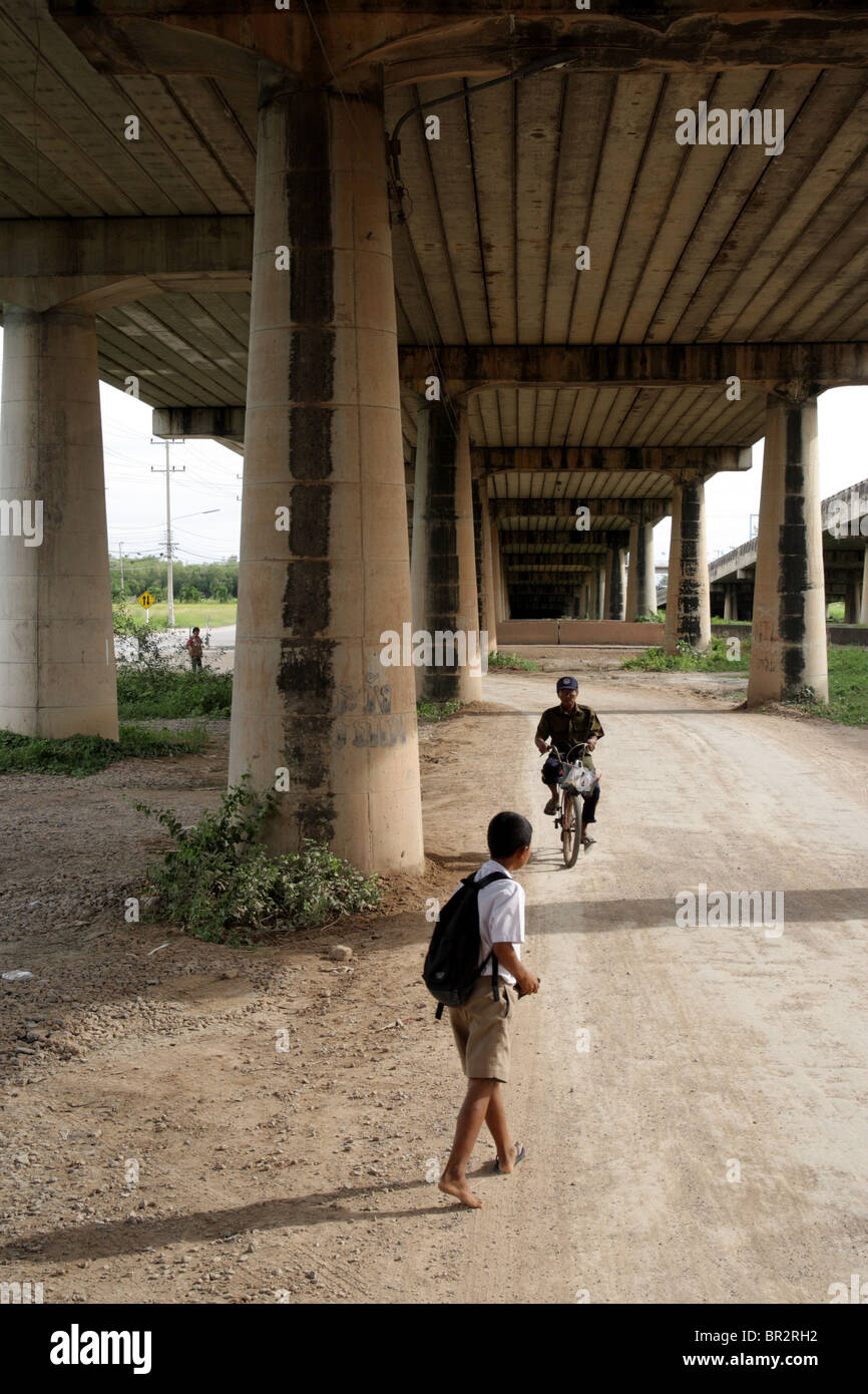Boy walking under bridge Stock Photo - Alamy