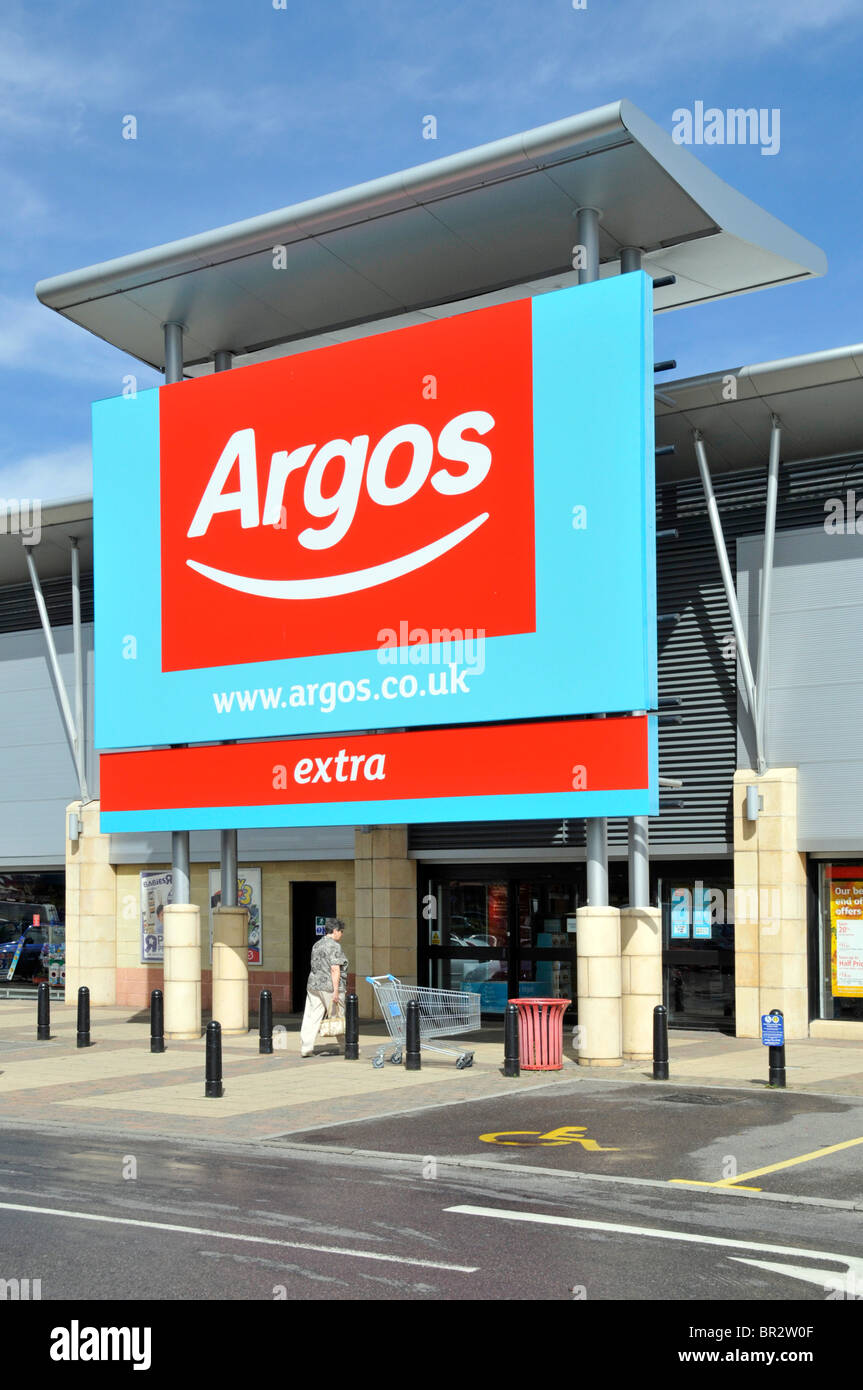 Model release woman shopper walking towards Argos Extra catalogue store ...