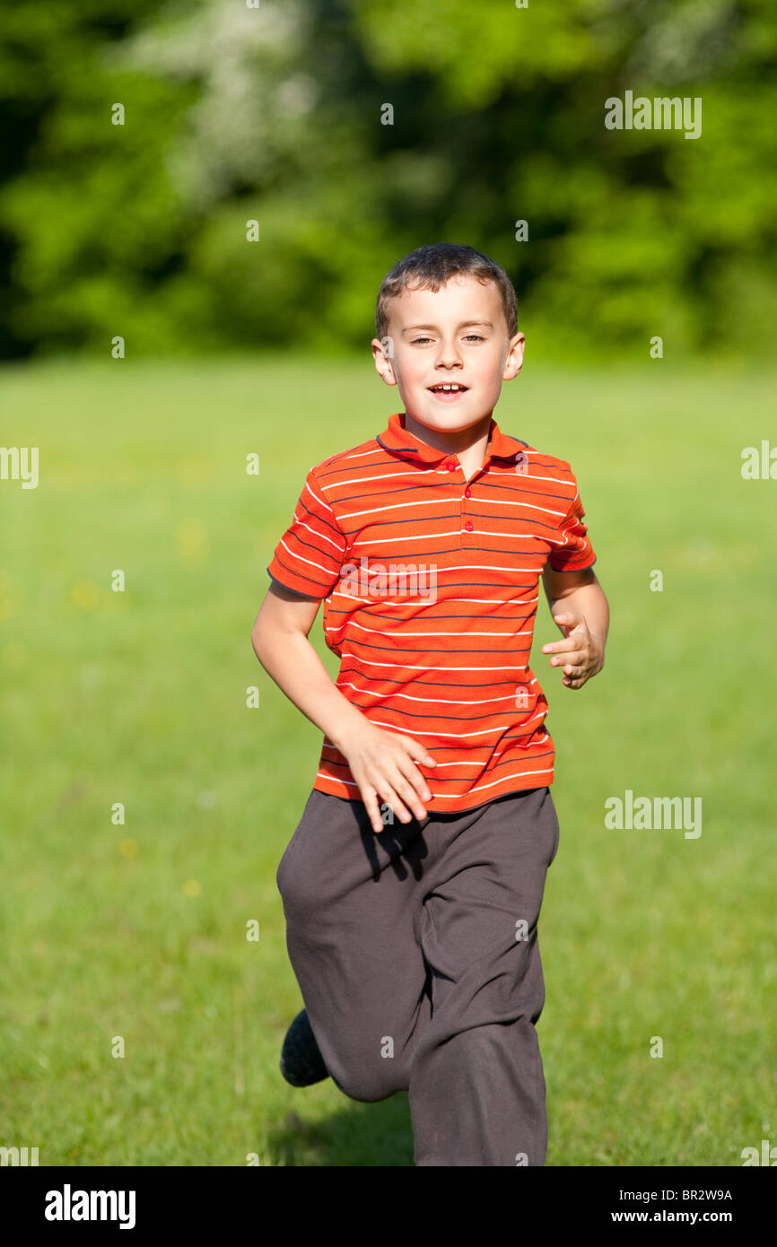 Little boy running outdoors on a meadow Stock Photo - Alamy