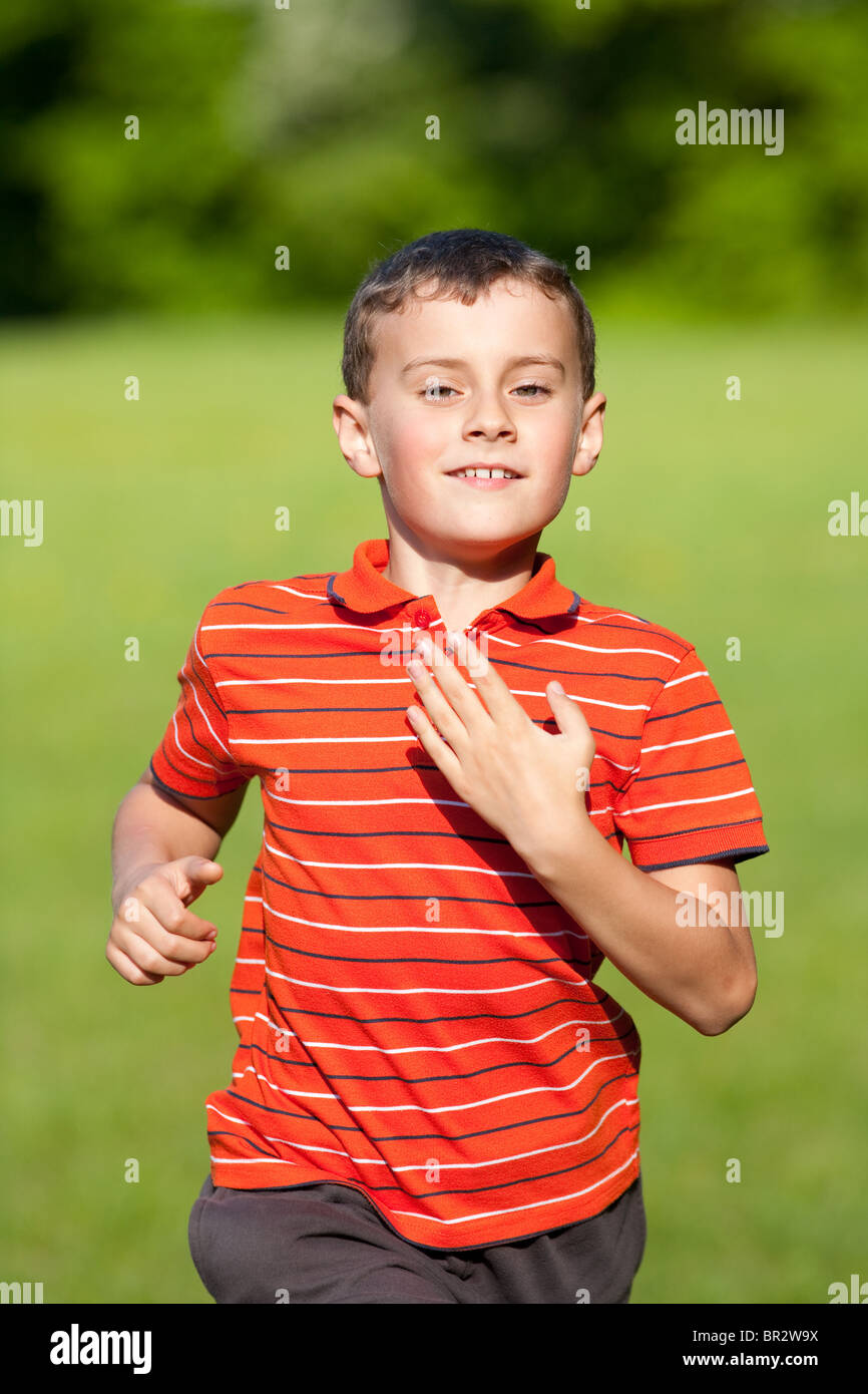 Little boy running outdoors on a meadow Stock Photo - Alamy