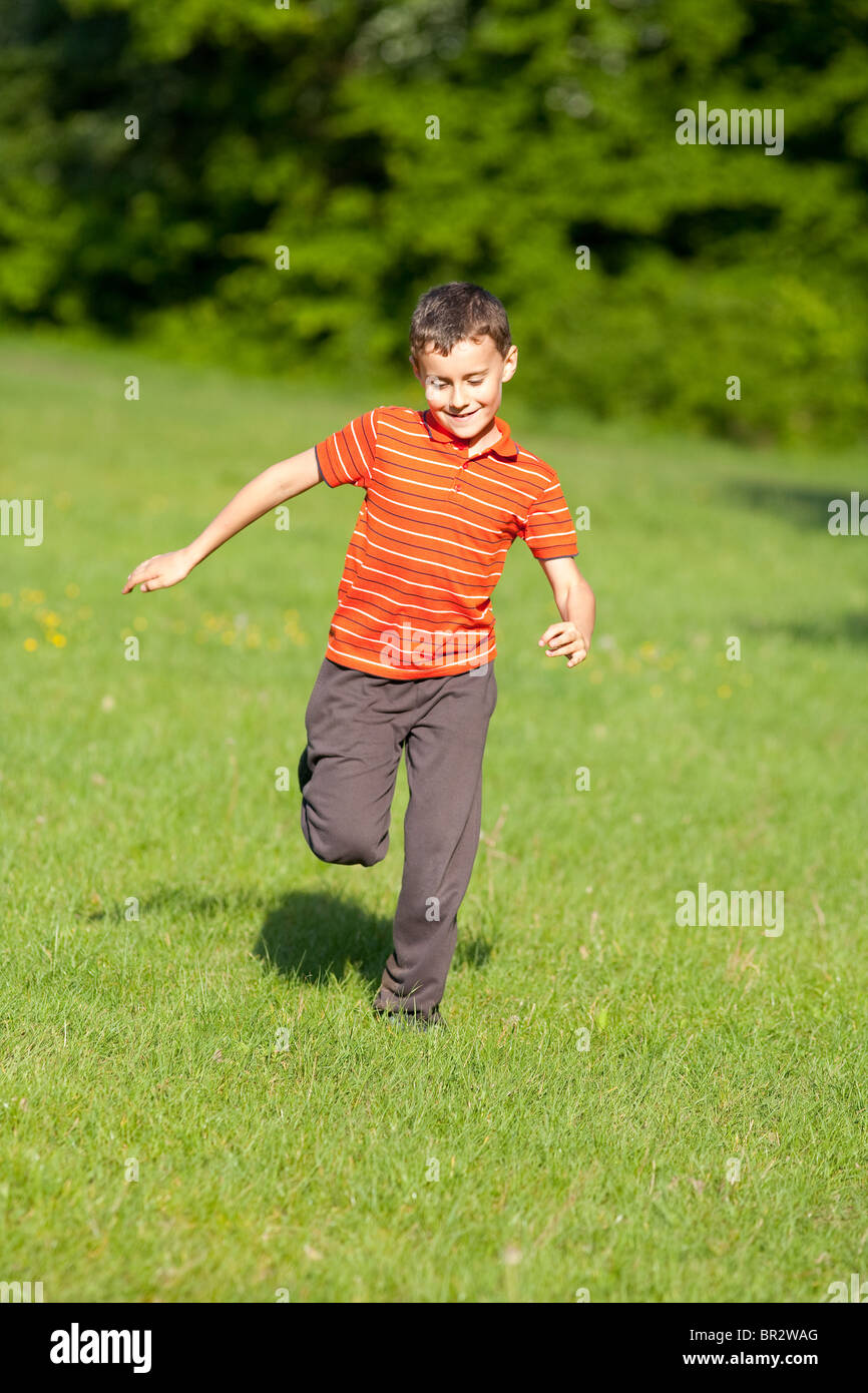 Little boy running outdoors on a meadow Stock Photo - Alamy