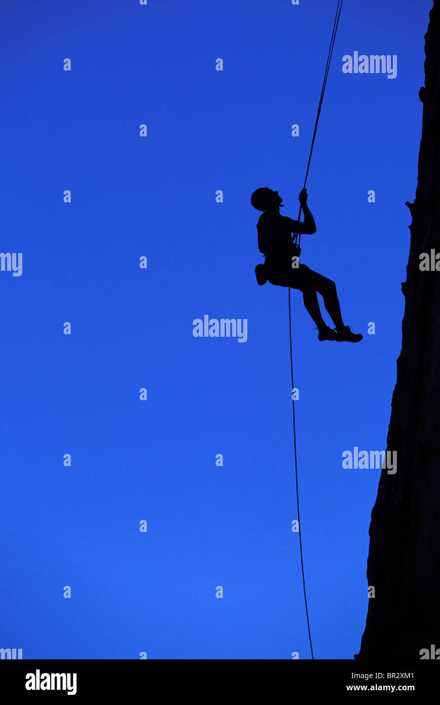 Silhouette of a climber rappelling Stock Photo - Alamy