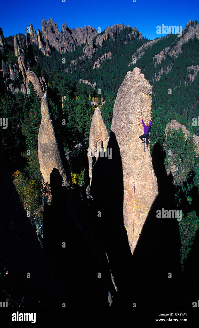 Man climbing a spire (high angle perspective Stock Photo - Alamy