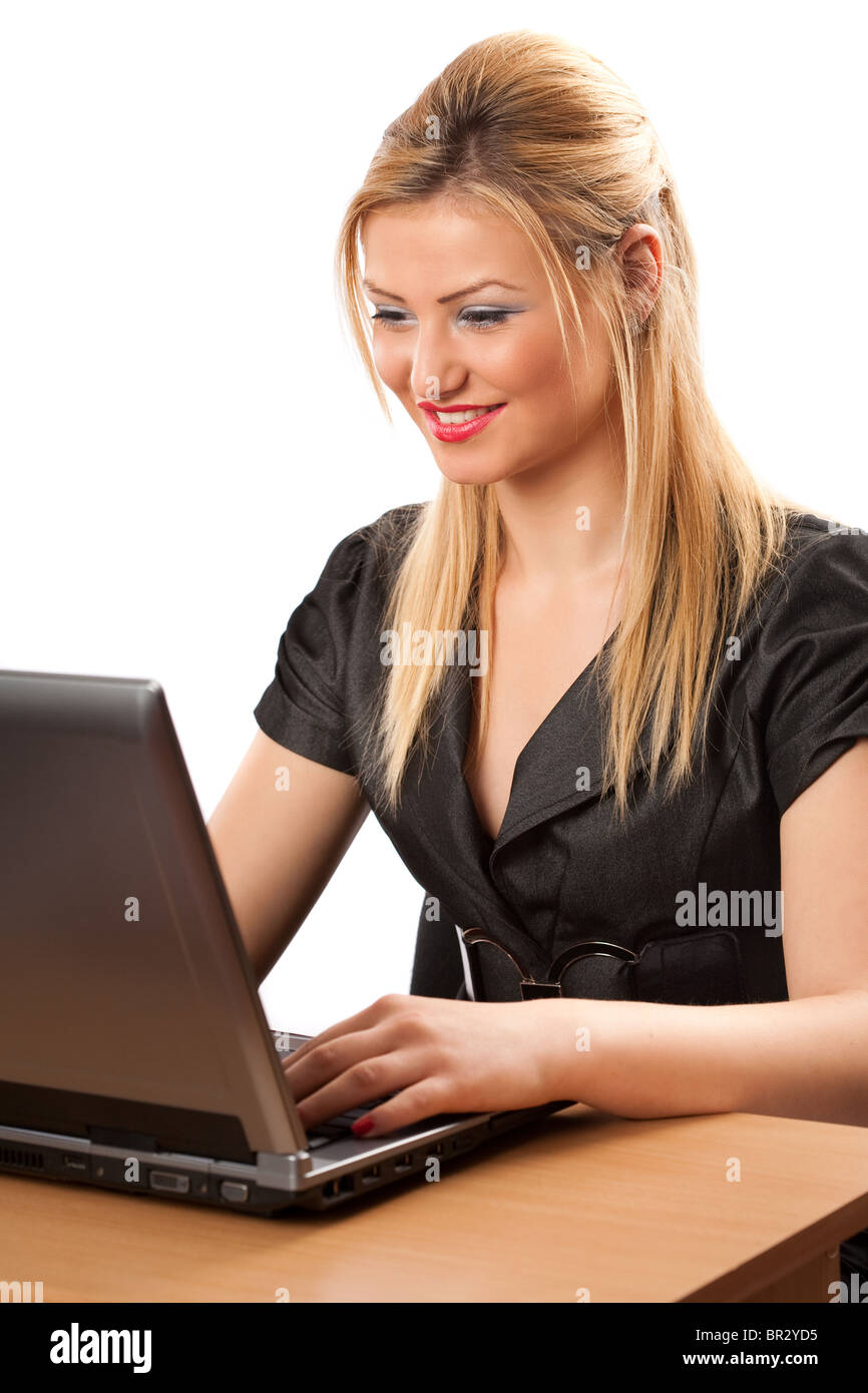 Beautiful blonde businesswoman at her desk with a laptop Stock Photo ...