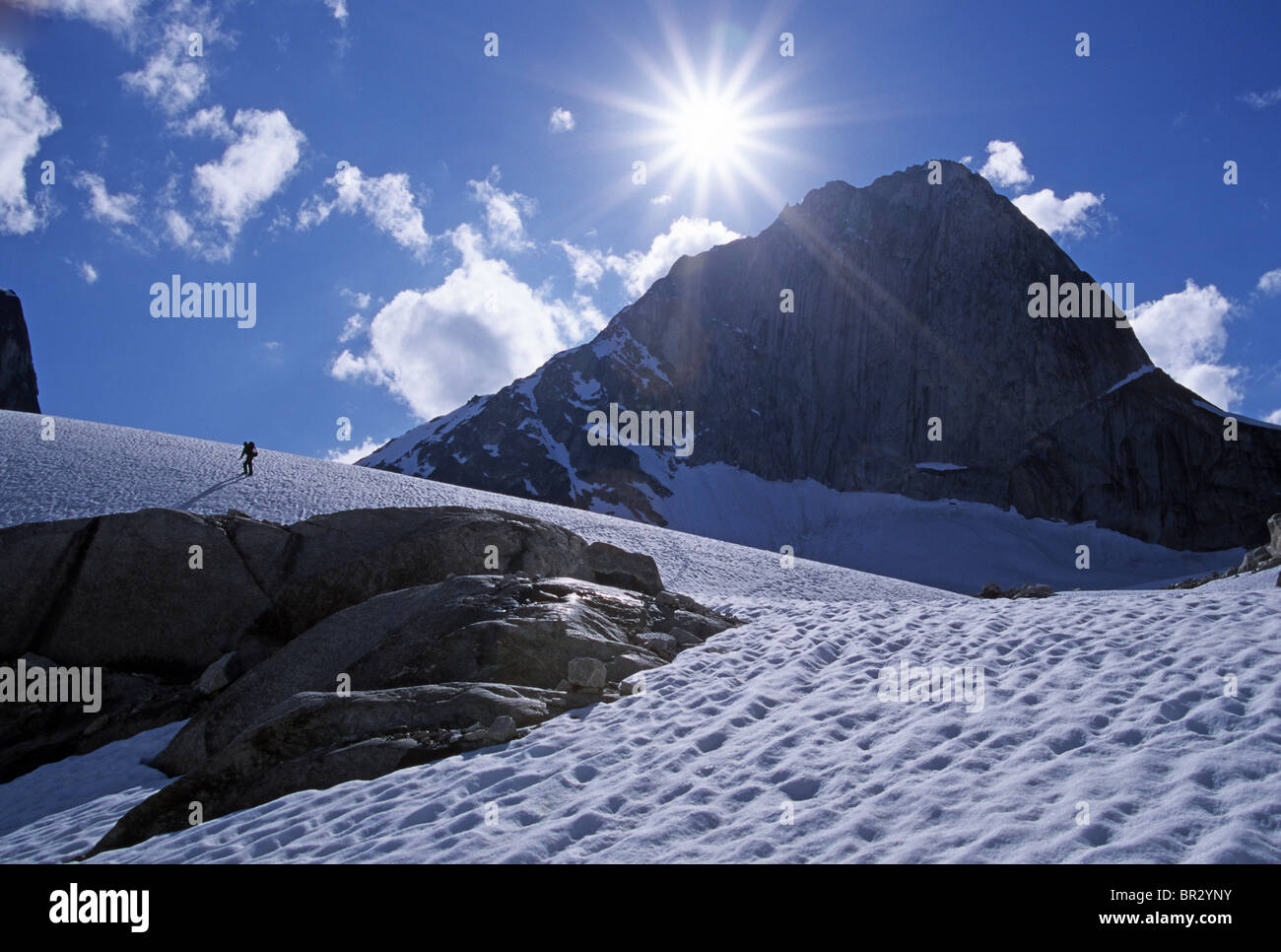 People hiking to climb in snowy alpine environment Stock Photo - Alamy