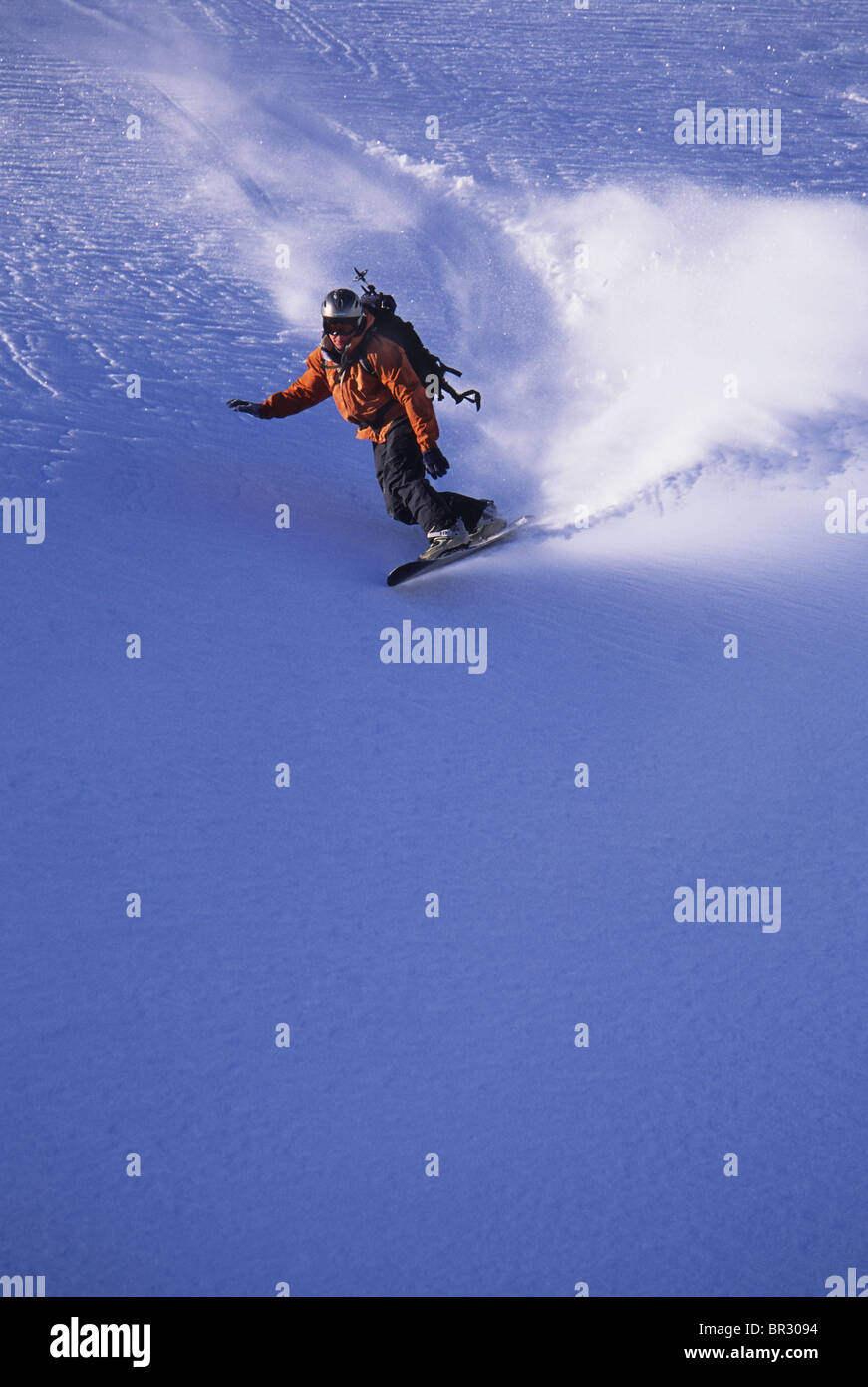 Snowboarder carving turn in open backcountry slope Stock Photo - Alamy