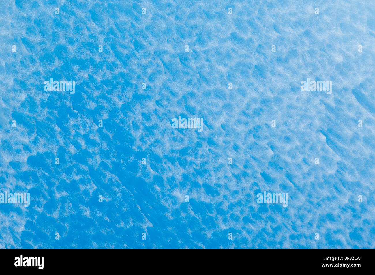 The blue pattern on an iceberg floating in the water in Tracy Arm near ...