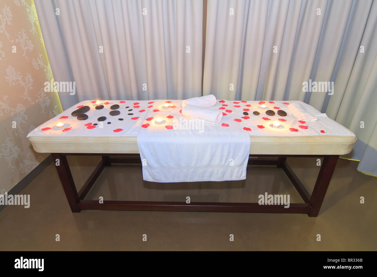 Decorated massage table in spa Stock Photo - Alamy