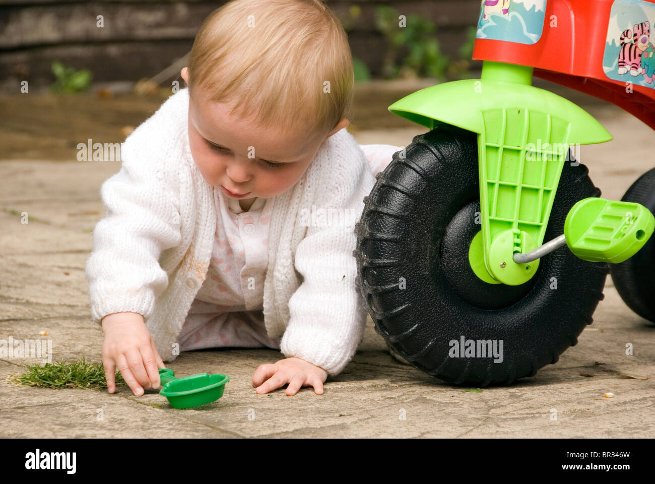 Portrait of Baby Girl Learning to Crawl and Investigating Toys in ...