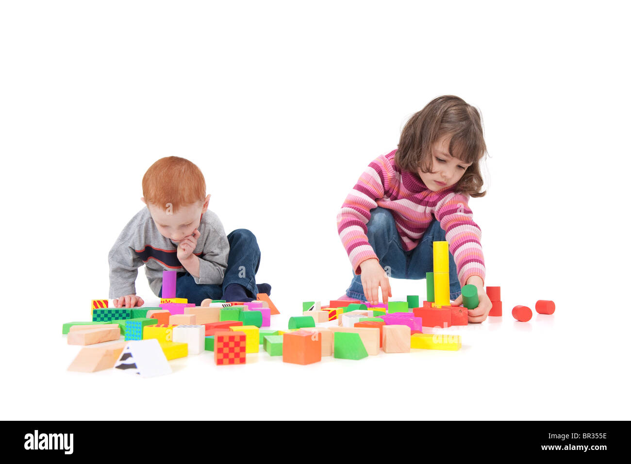 Two kids building block towers. Isolated on white with shadows Stock ...